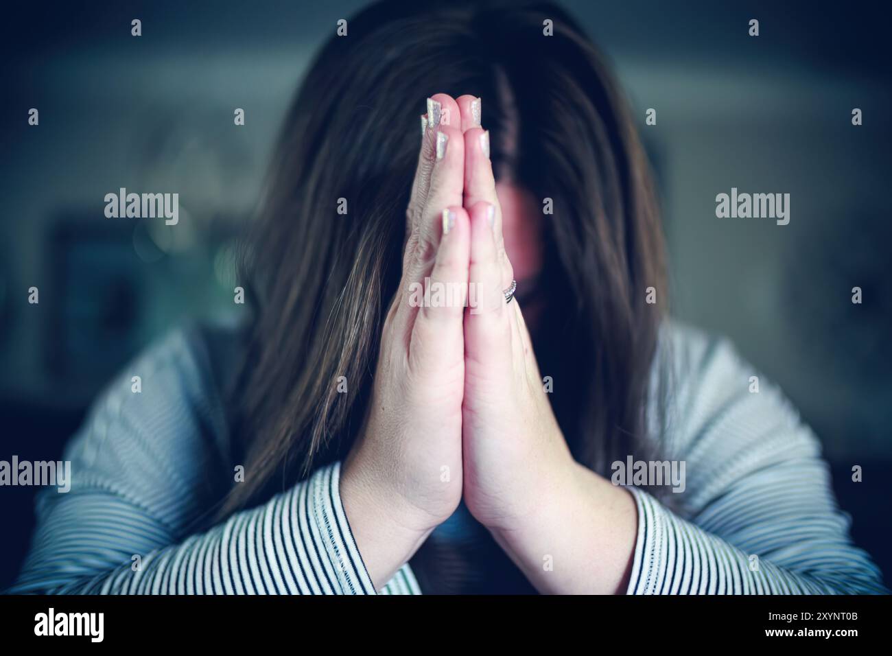 Close-up Portrait of a Woman with Hands Folded in Front of Her Face ...