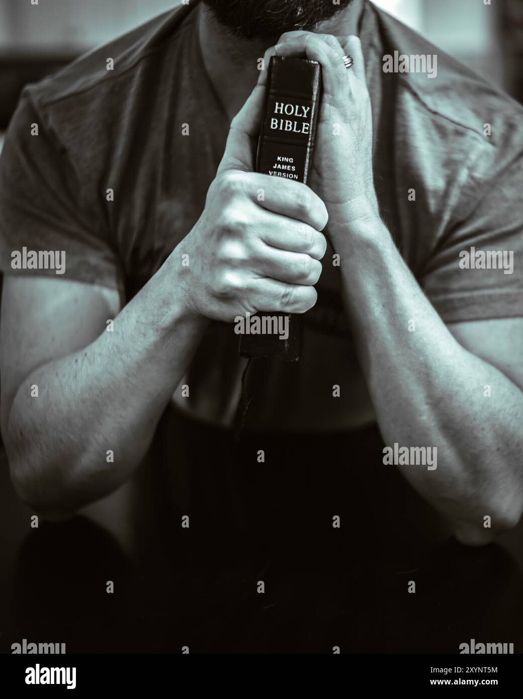 Close-up of fit man holding Leather Bible with Holy Bible Focused ...