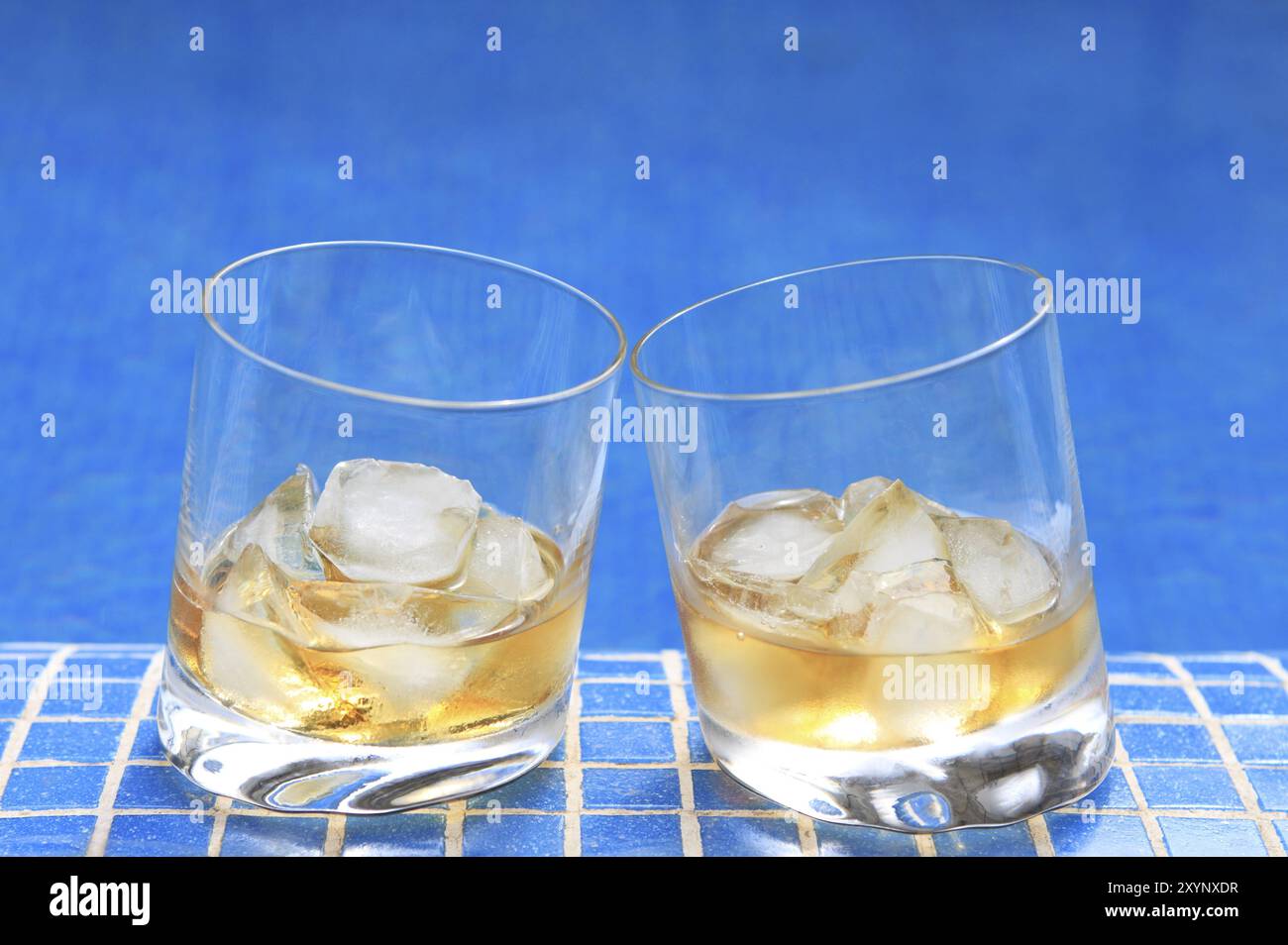 Whiskey near the pool. On the blue background Stock Photo - Alamy