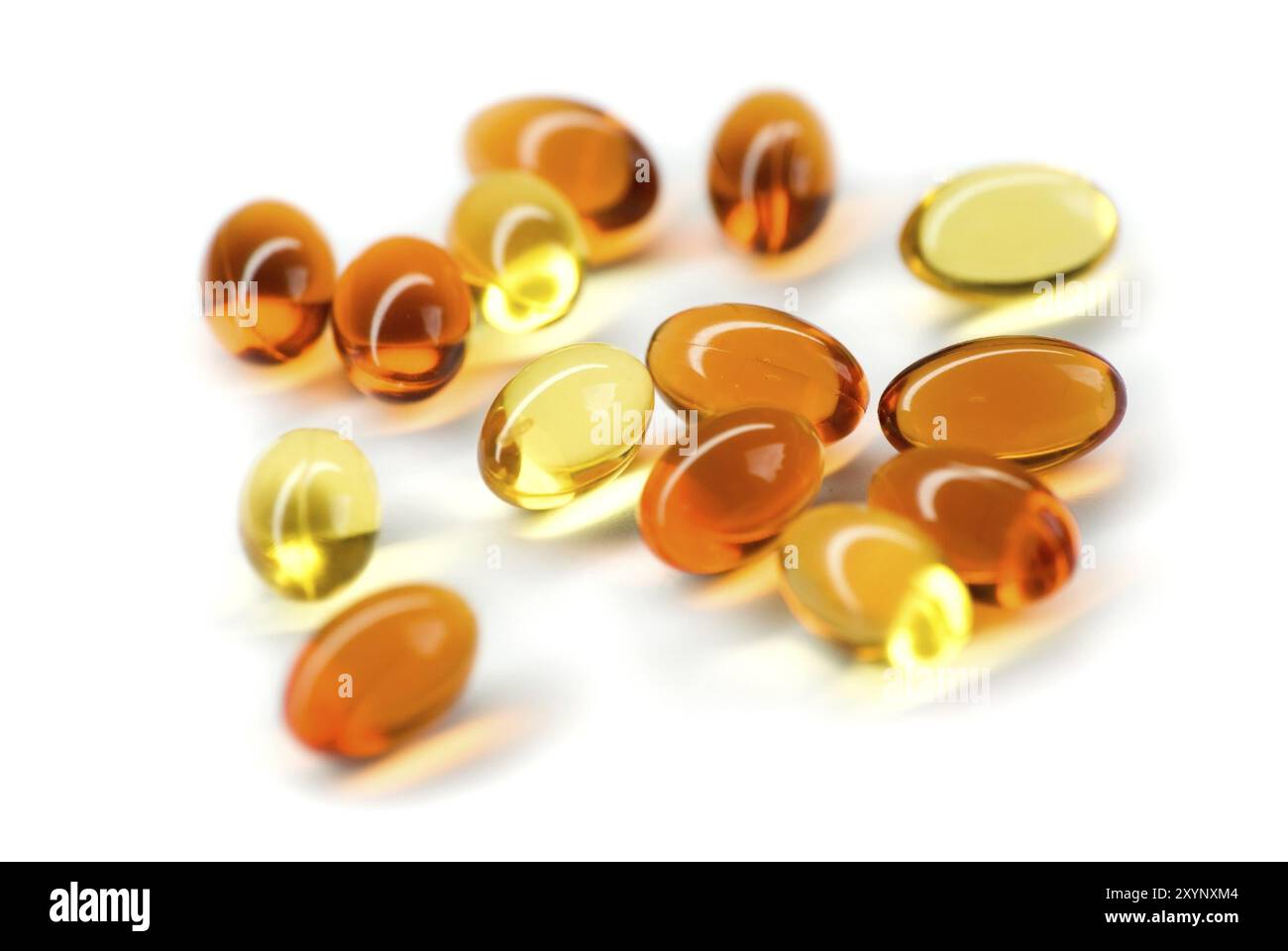 Golden and red capsules on white Stock Photo - Alamy