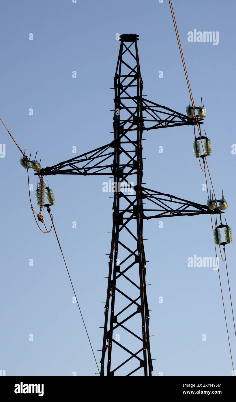 High voltage pylon and power line in warm evening light Stock Photo - Alamy