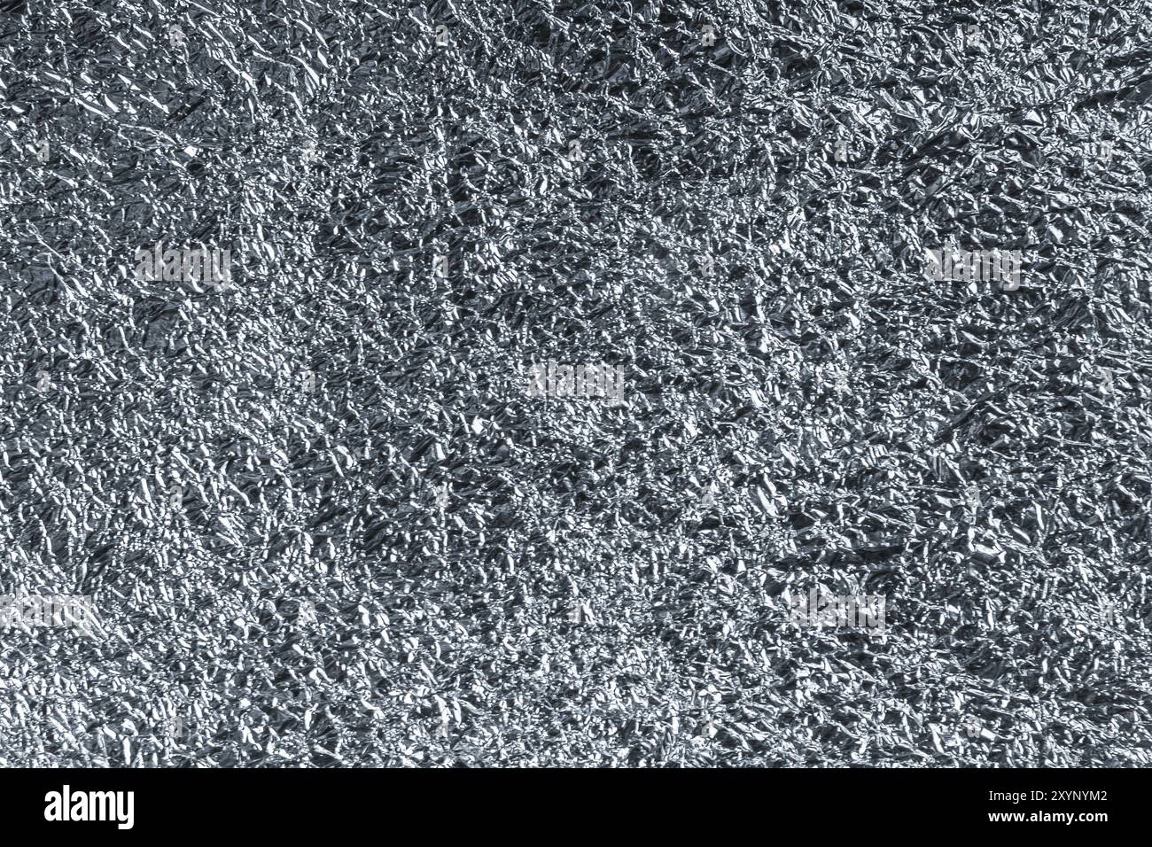 Silver leaf foil background with shiny crumpled uneven surface for texture and background Stock ...