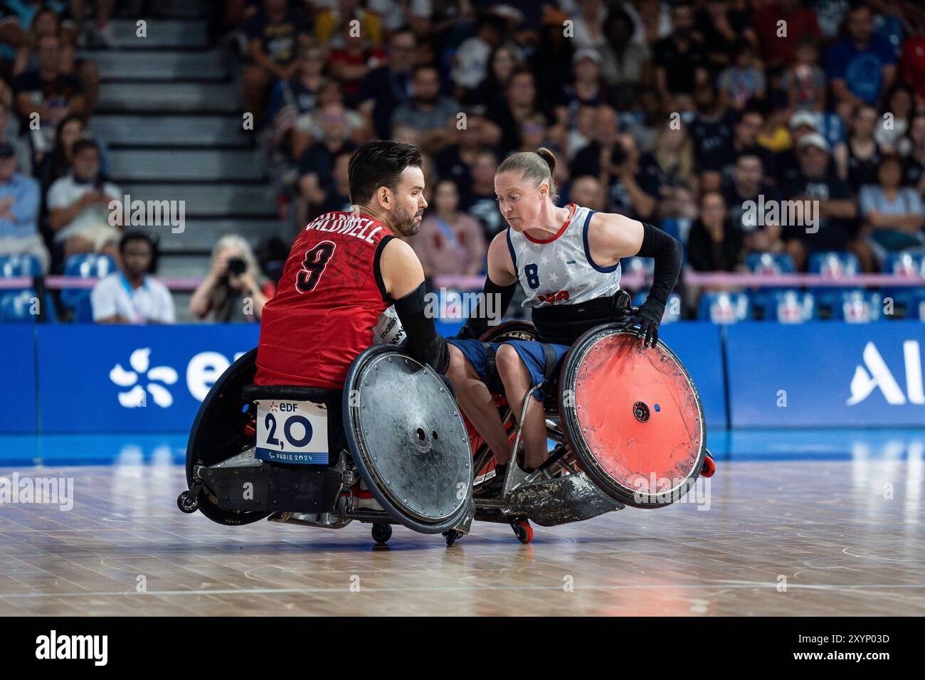 Sarah Adam (8) of the USA collides with Cody Caldwell (9) of Canada ...