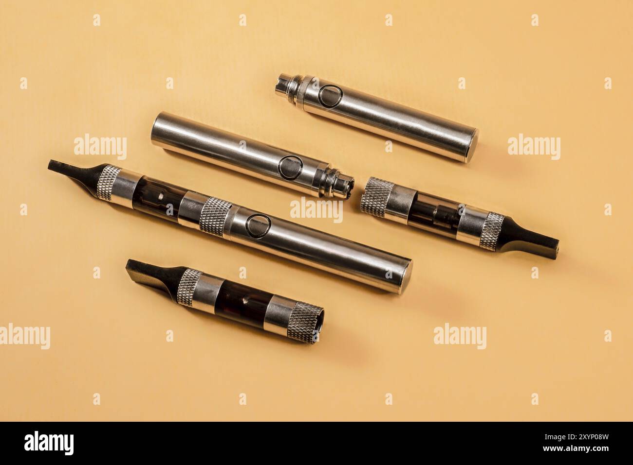 The different parts of an electronic cigarette displayed with three ...