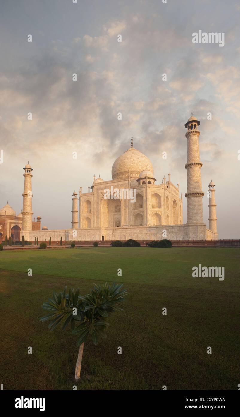 Fiery sky behind iconic orange glowing marble of Taj Mahal and front ...