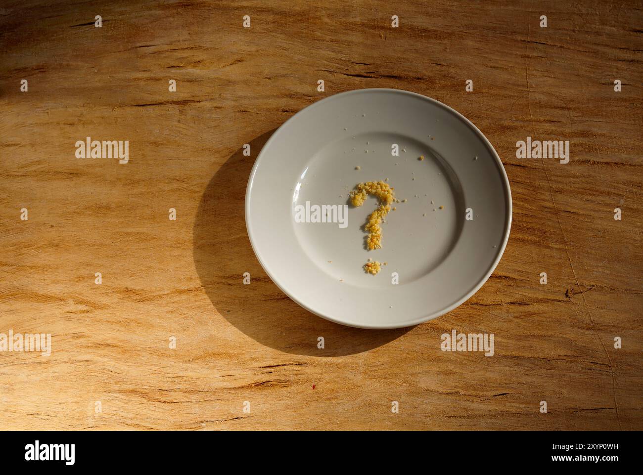 Bread crumbs forming a question mark on a plate. Hunger,inequity and ...