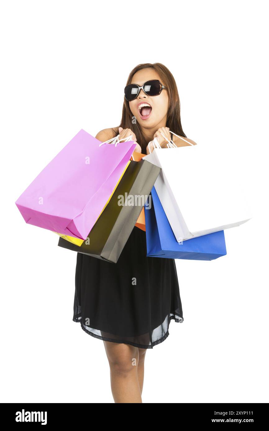 A cute Asian girl shopper in black dress, stylish sunglasses, playfully ...