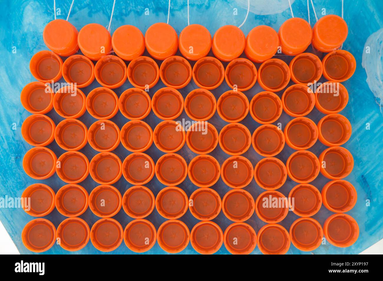 Orange color plastic containers on a blue background . Plastic bottle ...