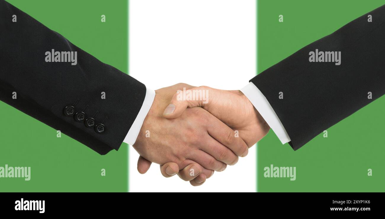 The Nigerian flag and business handshake Stock Photo - Alamy
