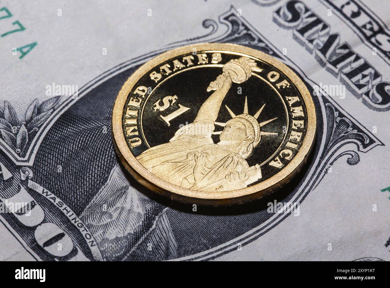 One dollar coin, The Statue of Liberty, on one dollar banknote. Closeup ...