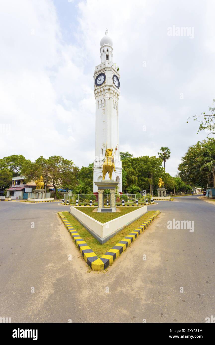 Golden horse mounted statue at intersection of white clock tower, a ...