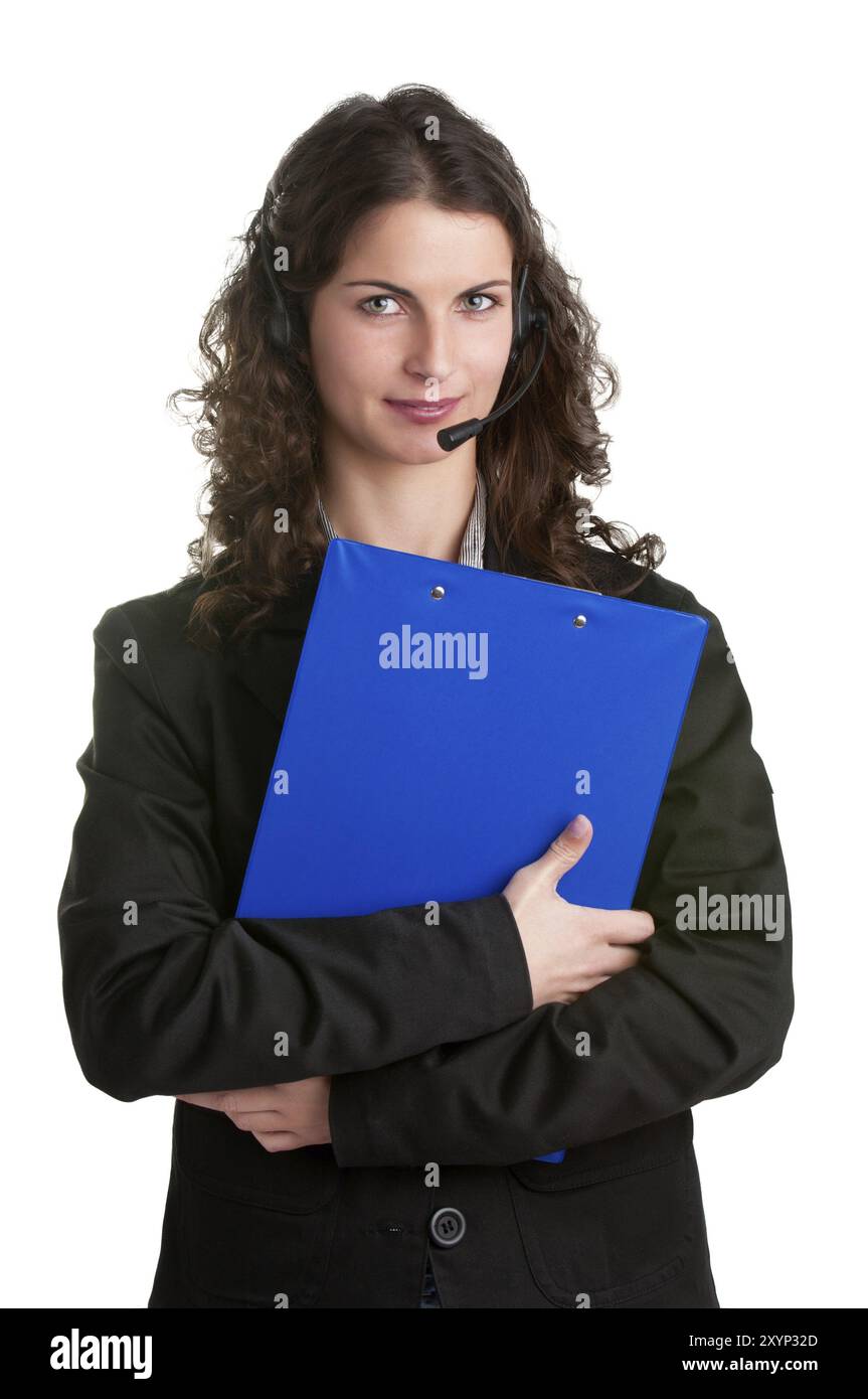 Corporate woman talking over her headset, isolated in a white background, holding a blue pad ...