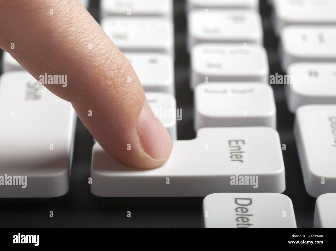 Finger pushing enter button on computer keyboard. Side view Stock Photo ...