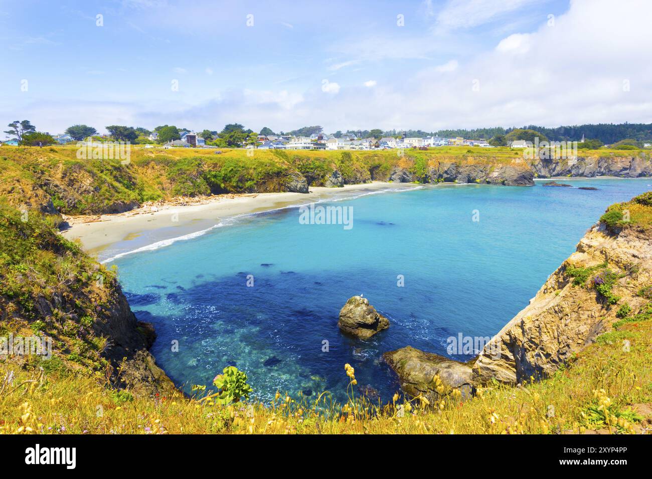 Beautiful azure cove below the cliffs near Main Street on a blue sky ...