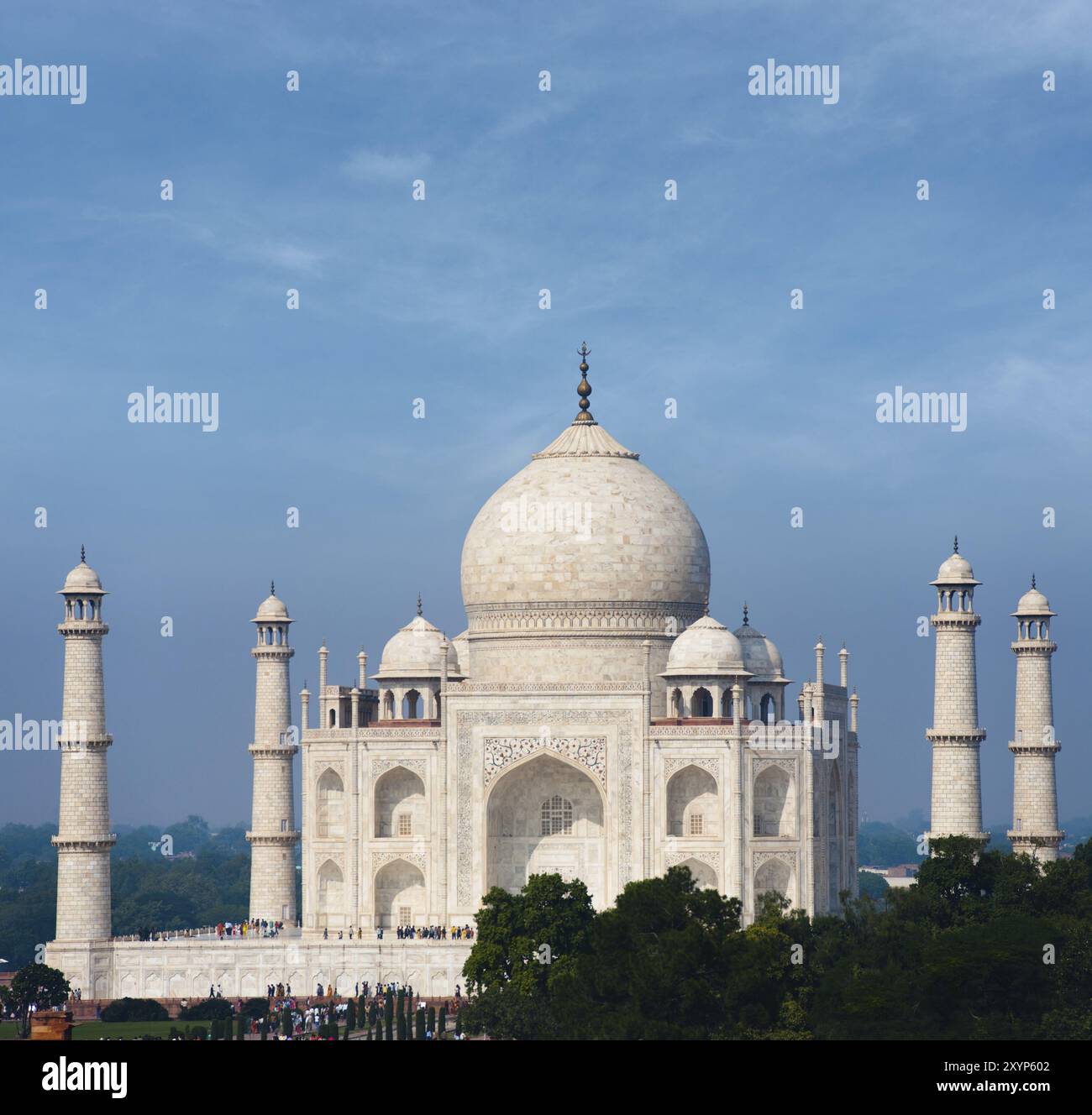 Distant telephoto view of sun shining brightly on white marble of the ...