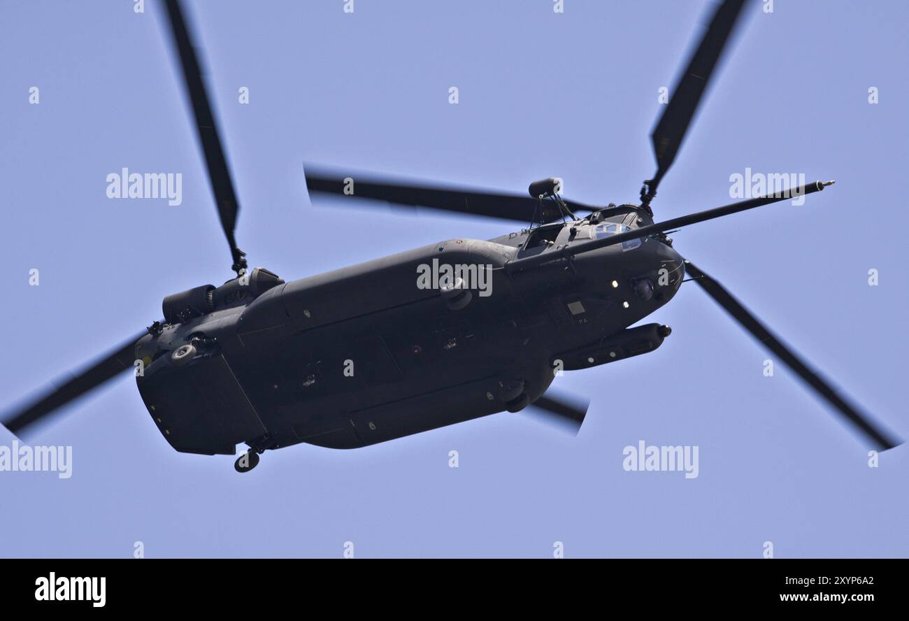 Military chinook helicopter over blue sky Stock Photo - Alamy