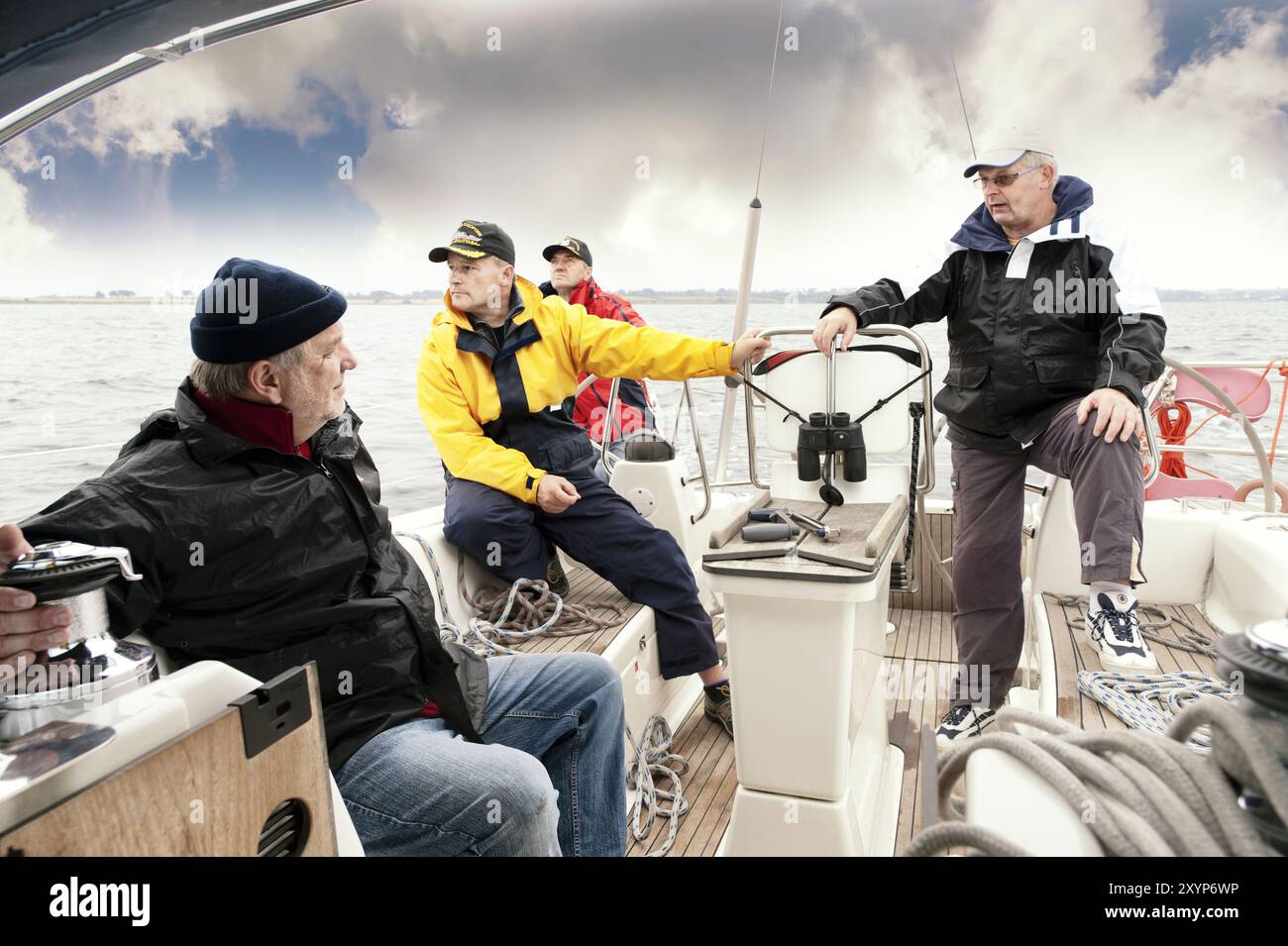 4 men on board a sailing yacht Stock Photo - Alamy