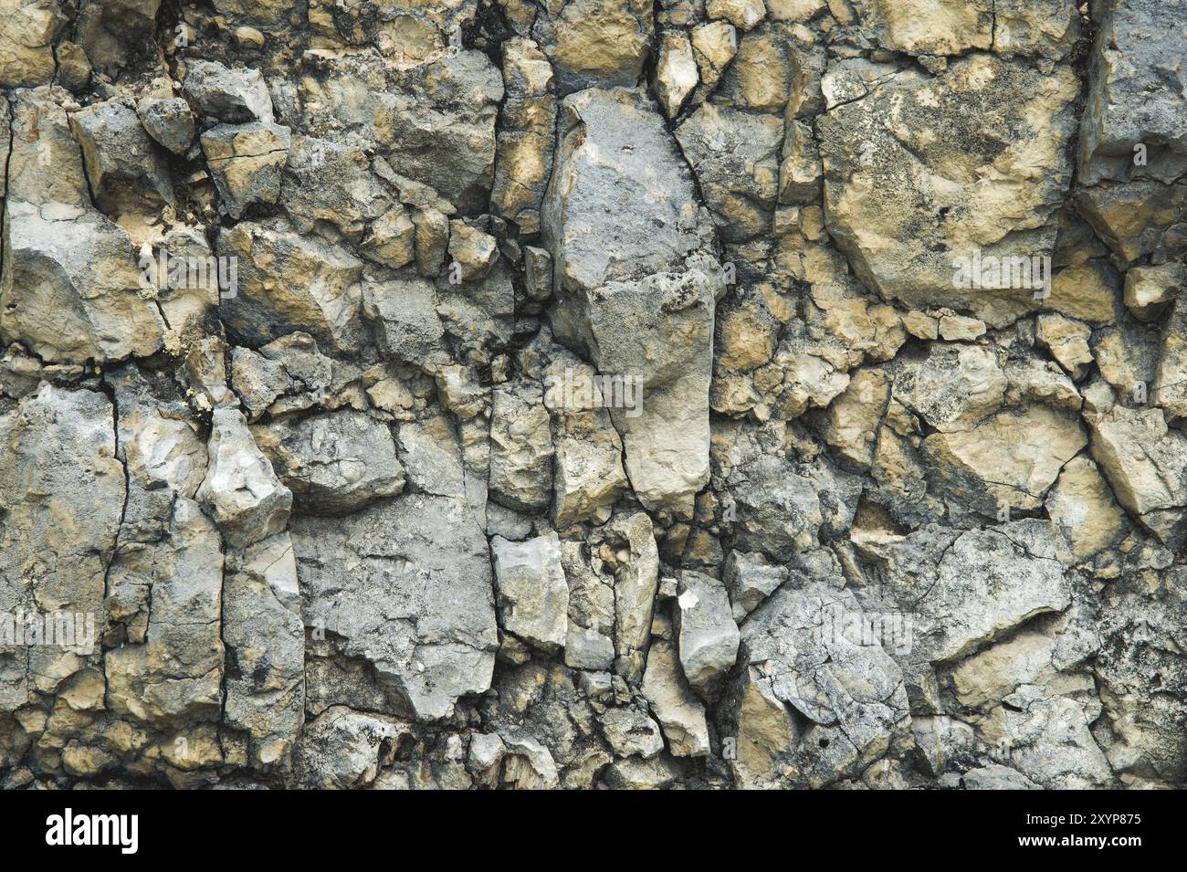 Pebble stones in a rocky wall. Natural background of a rocky stone wall ...