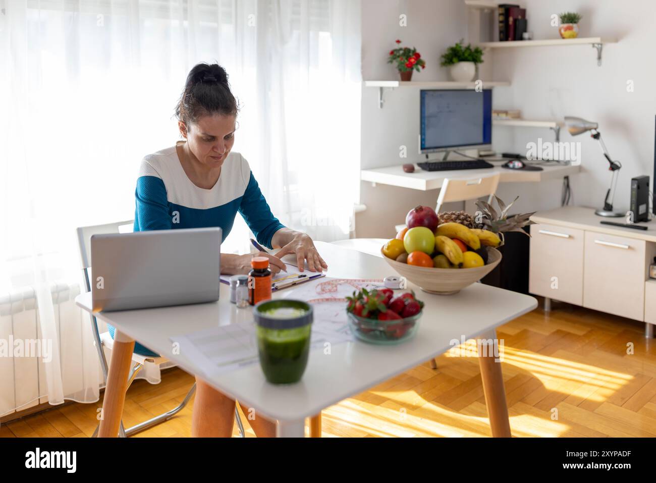 Nutritionist, dietitian woman writing a diet plan, with healthy fruits ...
