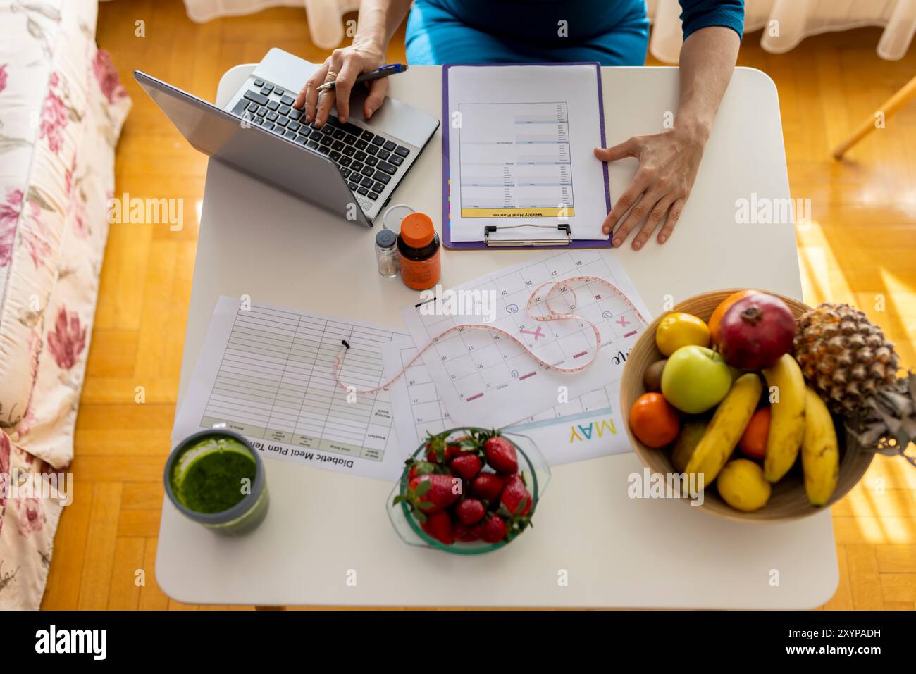 Dietitian writing a diet plan, view from above on the table with ...