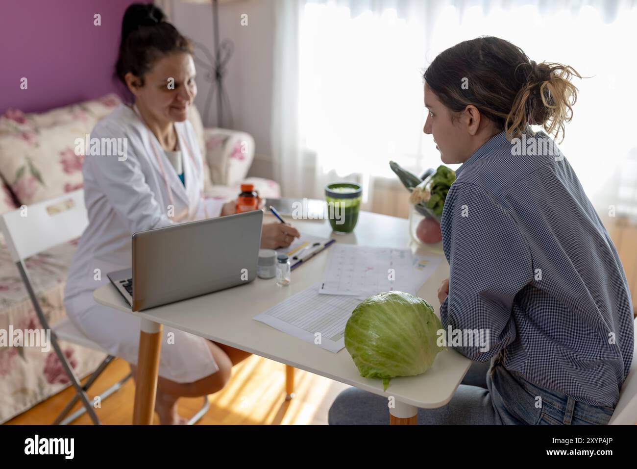 Doctor, nutritionist talking to client about health problems and ...