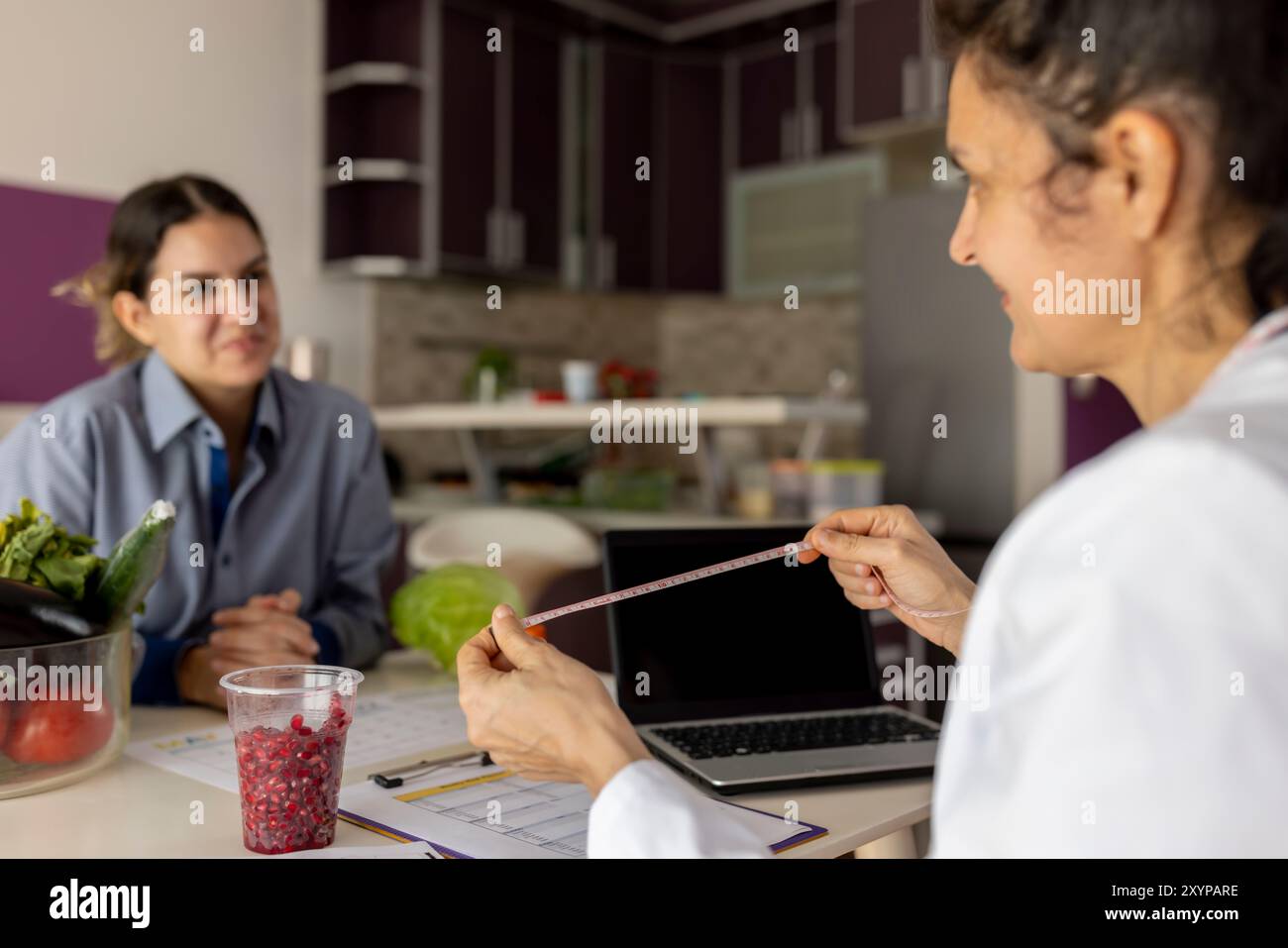 Doctor, nutritionist talking to client about health problems and ...