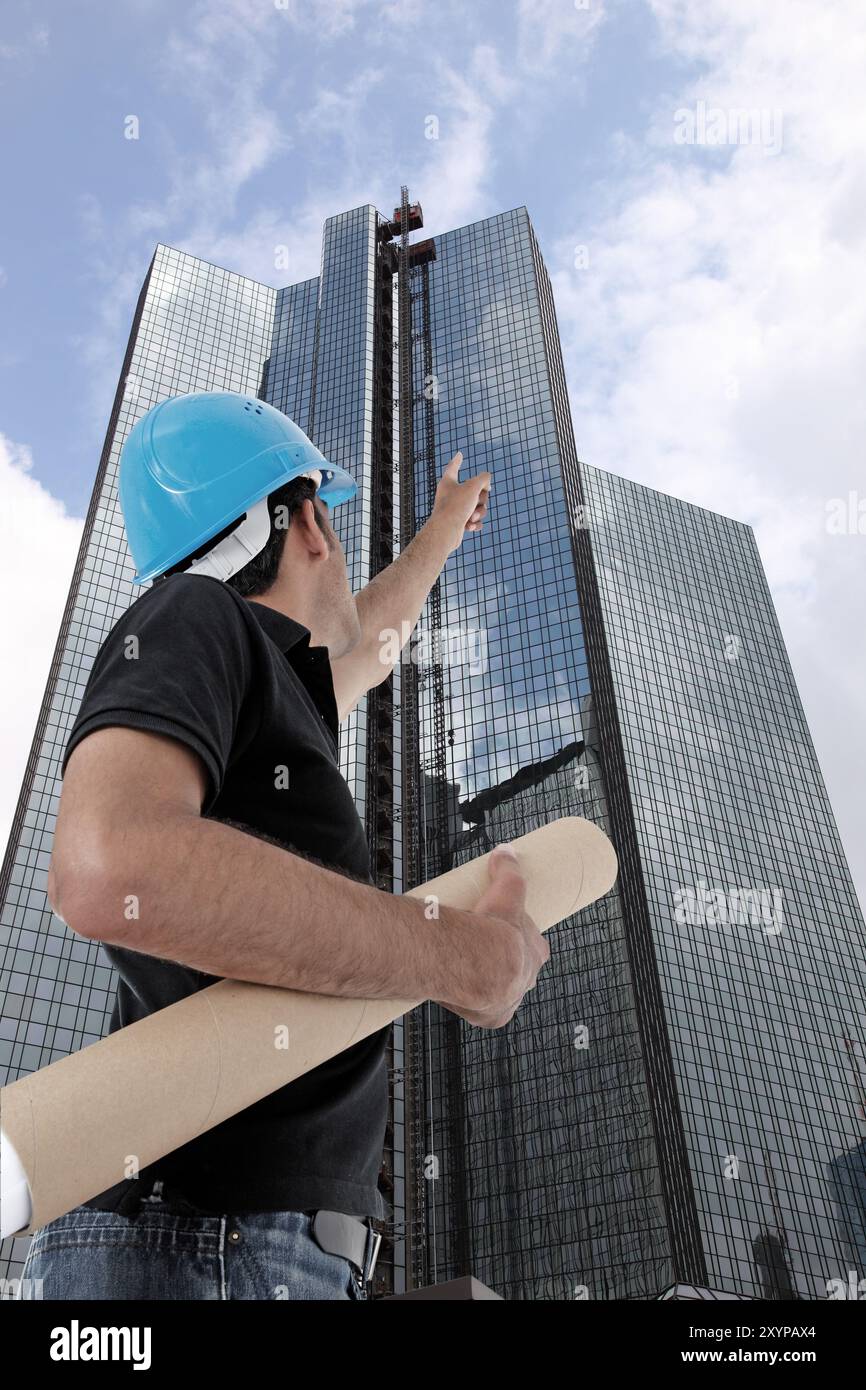 Architect with a building drawing under his arm in a cardboard roll ...