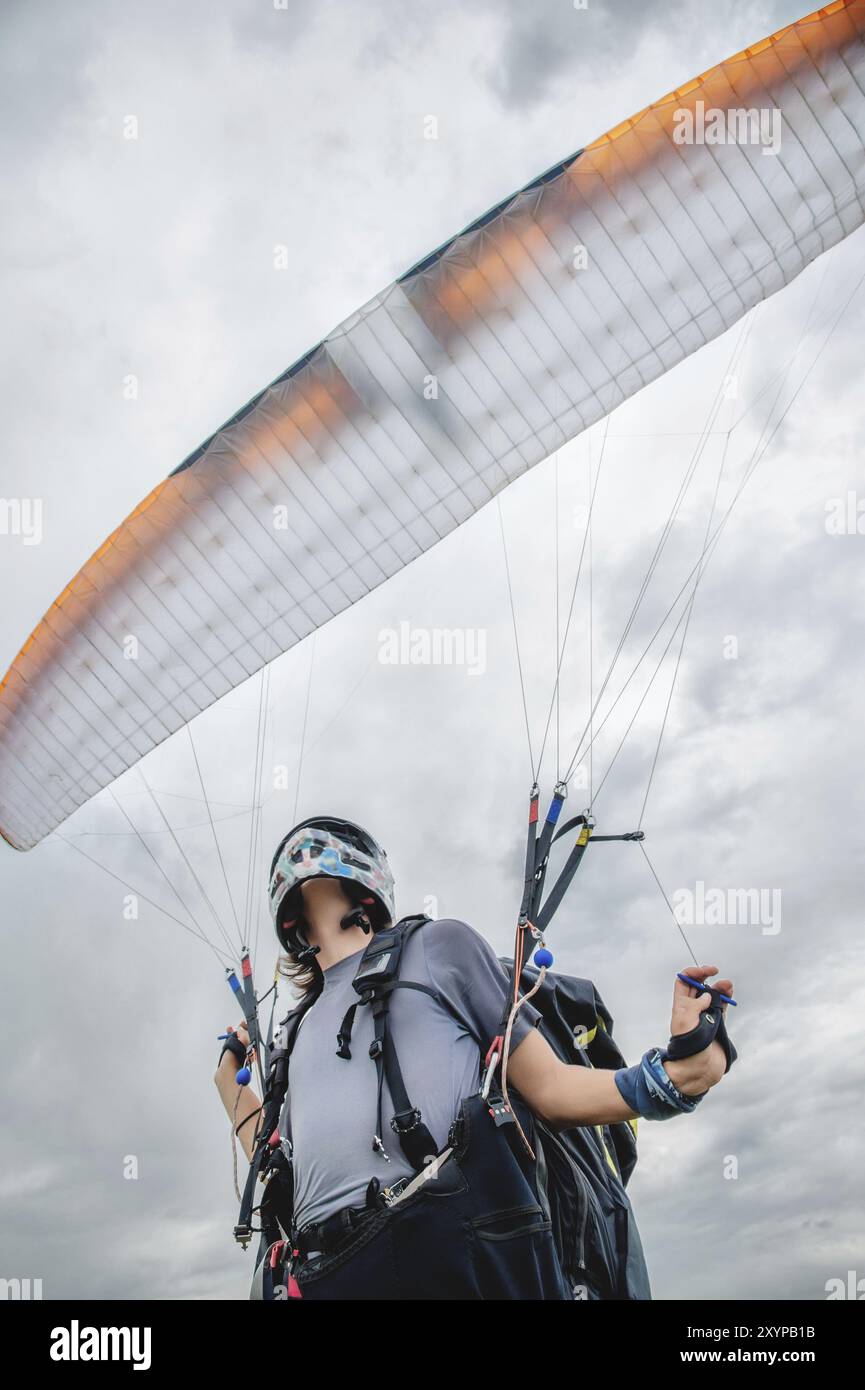 Close-up The paraglider opens his parachute before taking off. Filling ...