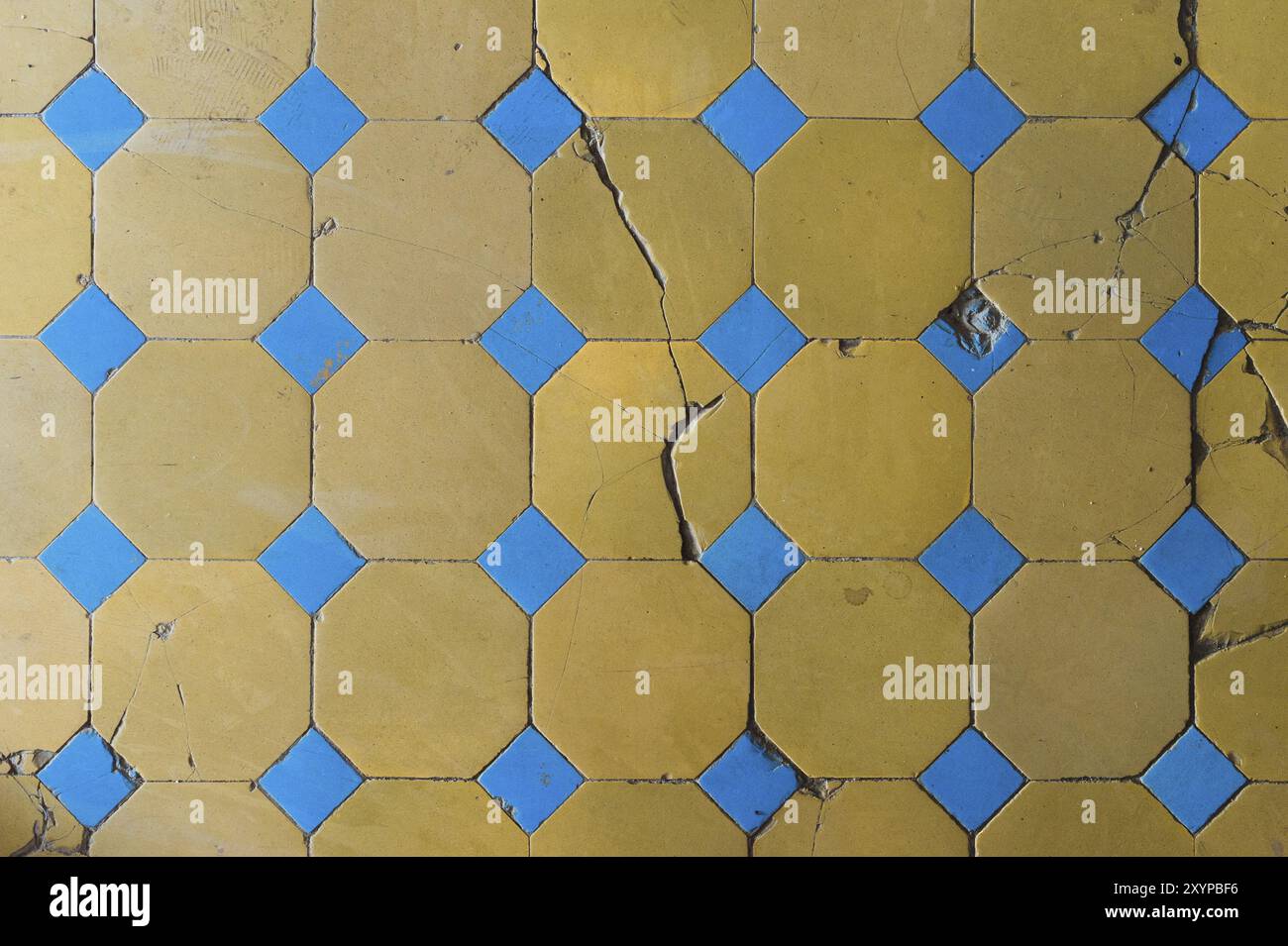 Close-up of an old floor tile with a two-tone pattern. Chapped floor ...