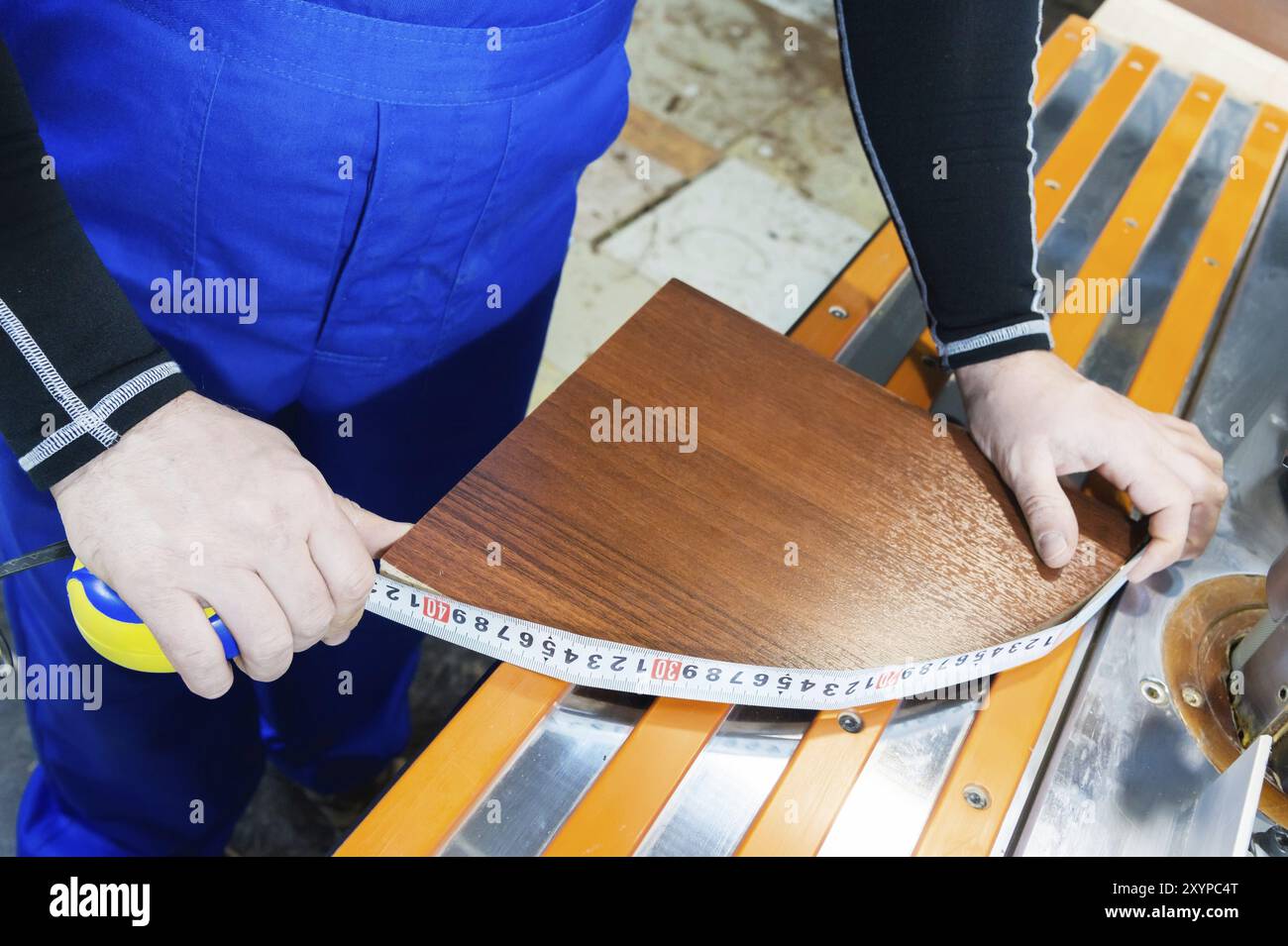 Closeup of Carpenter's hands using one meter in a cottage workshop ...