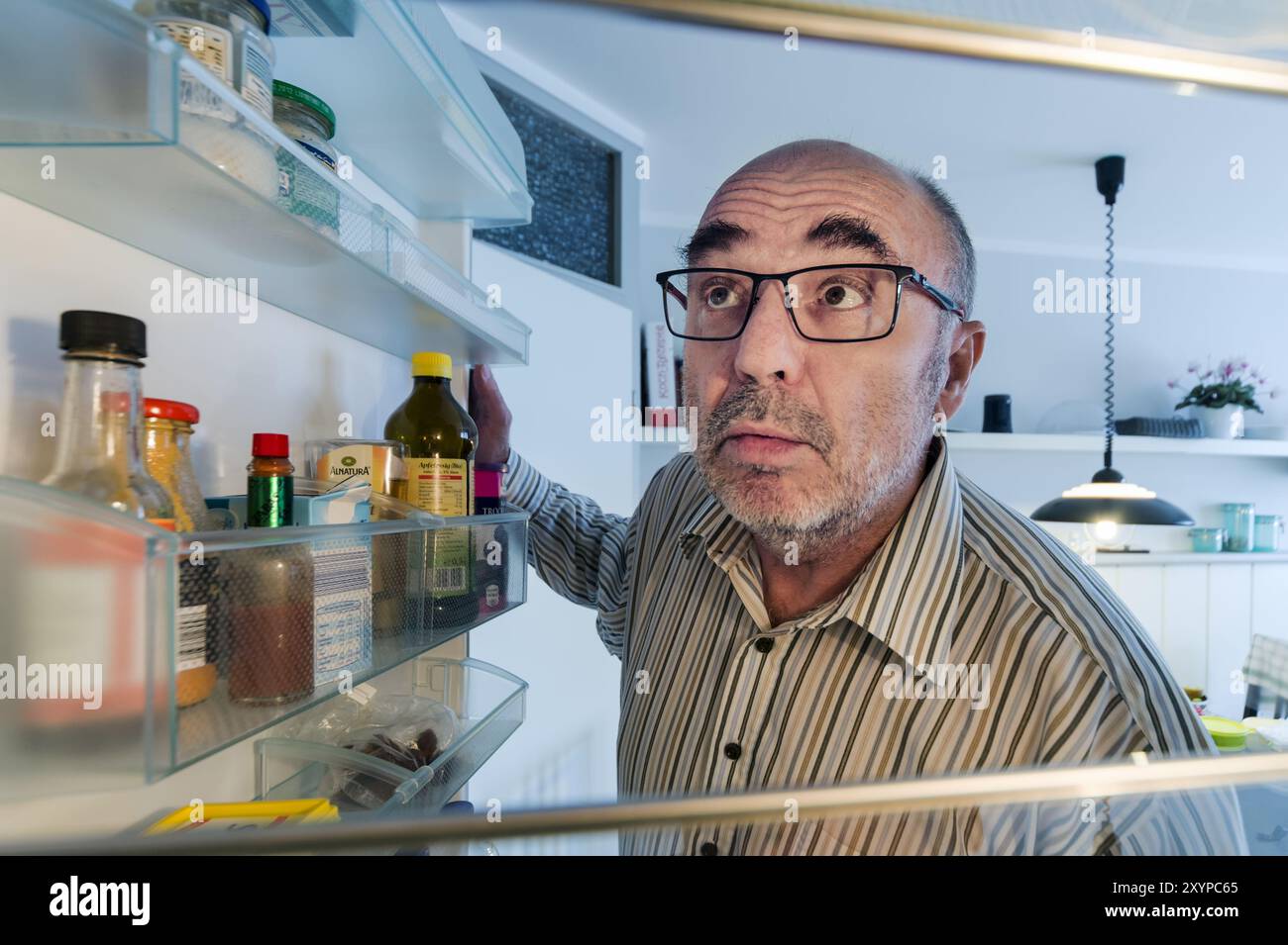 Man looking inside fridge hi-res stock photography and images - Alamy