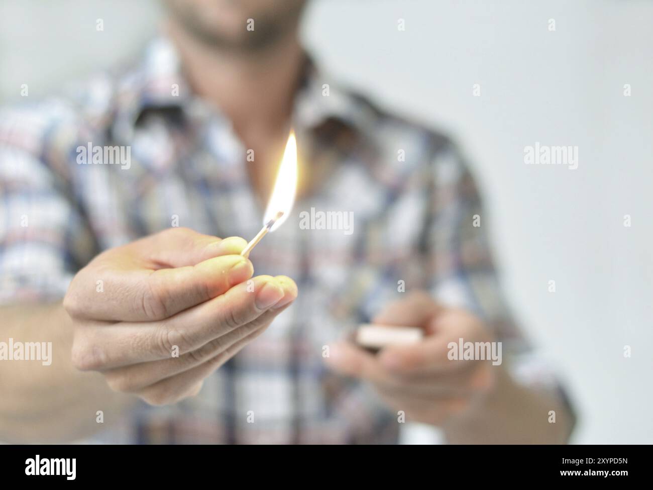 Man lights a fire with a match Stock Photo - Alamy