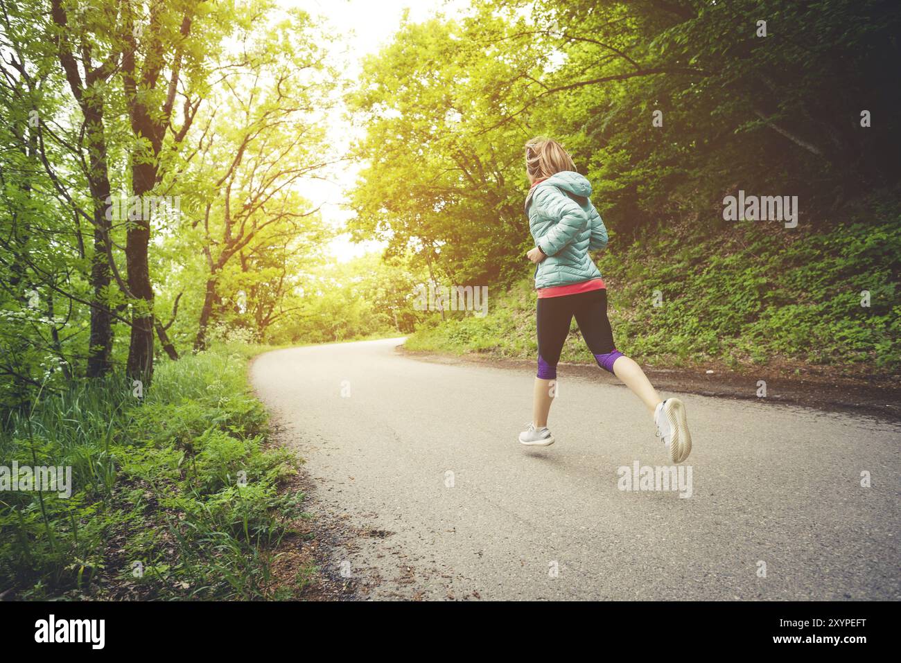 Young fitness blonde woman in headphones running at morning caucasian ...
