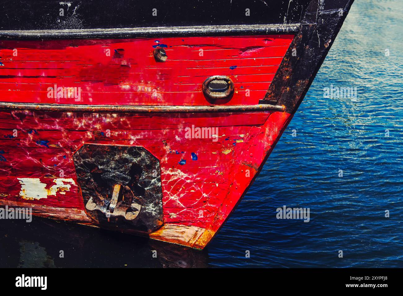 Bow of a red ship in front of blue water Stock Photo - Alamy