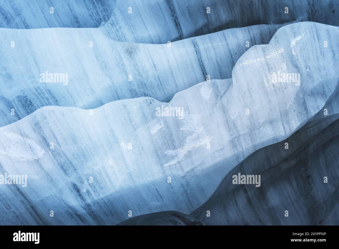 Close-up the ceiling of an ice grotto in a crumbling glacier. Textured ...