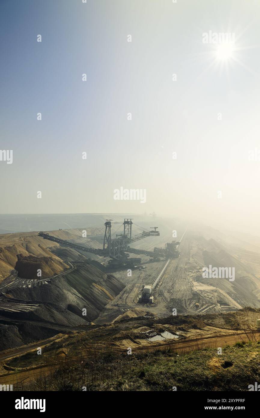 Large-scale equipment in the Garzweiler open-cast mine backlit by the ...