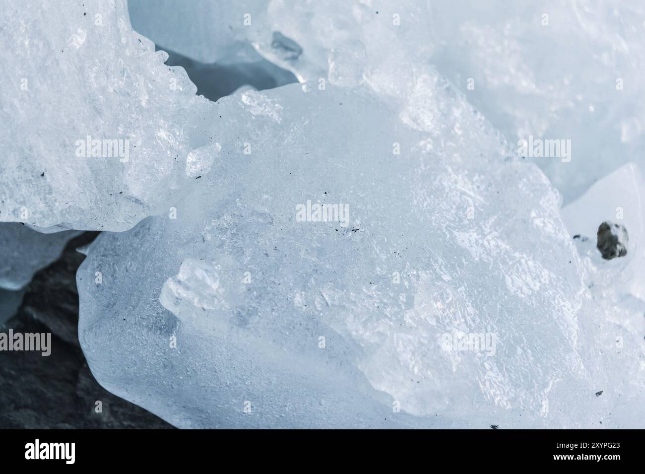 Close-up pieces of ice showered in the ice grotto of a glacier. The ...