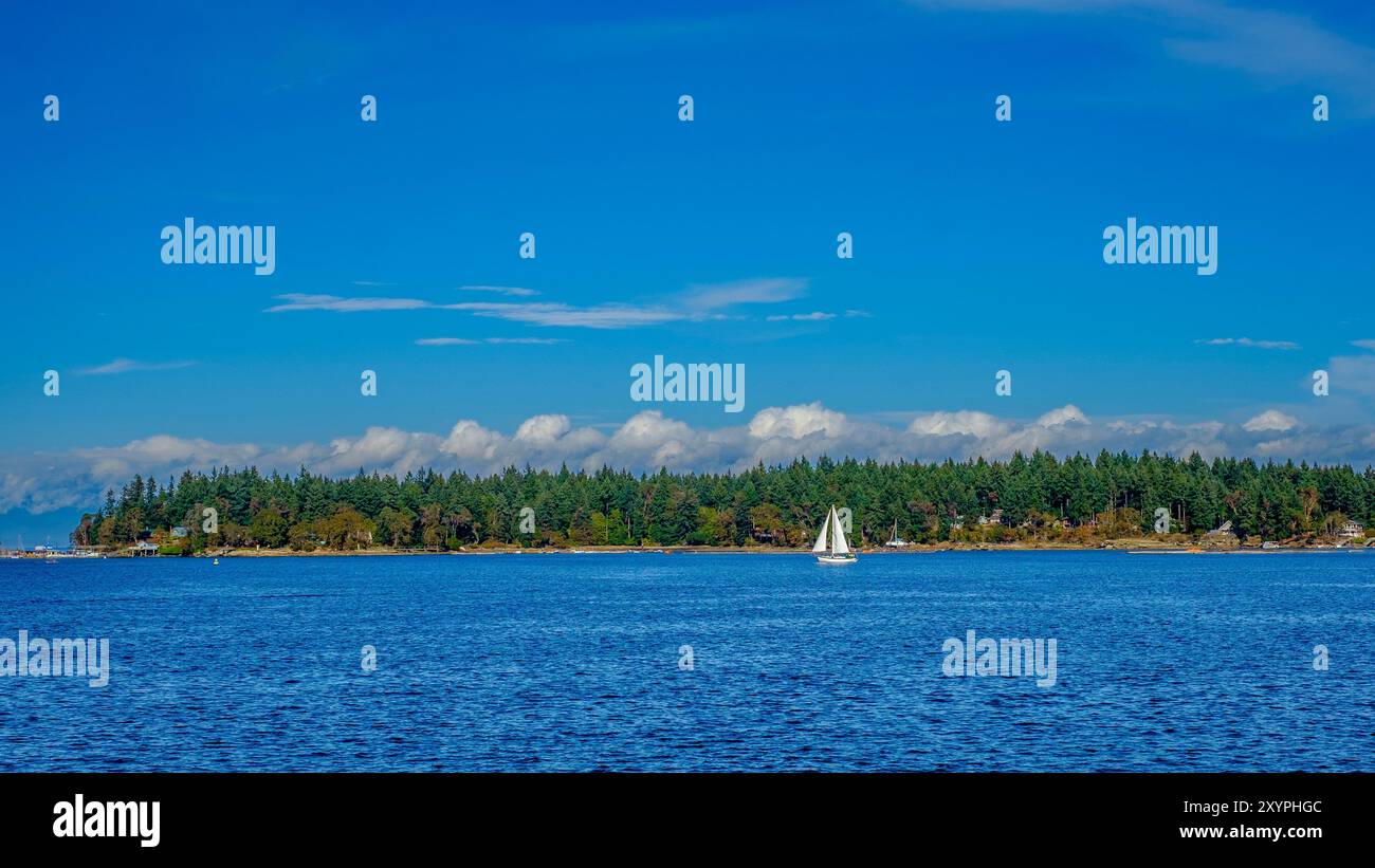 A sailboat sails past Protection Island entering Nanaimo Harbour Stock ...