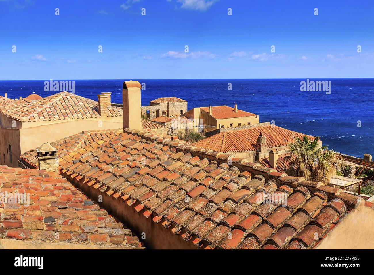 Monemvasia old red brick houses, roofs in ancient town and blue sea ...