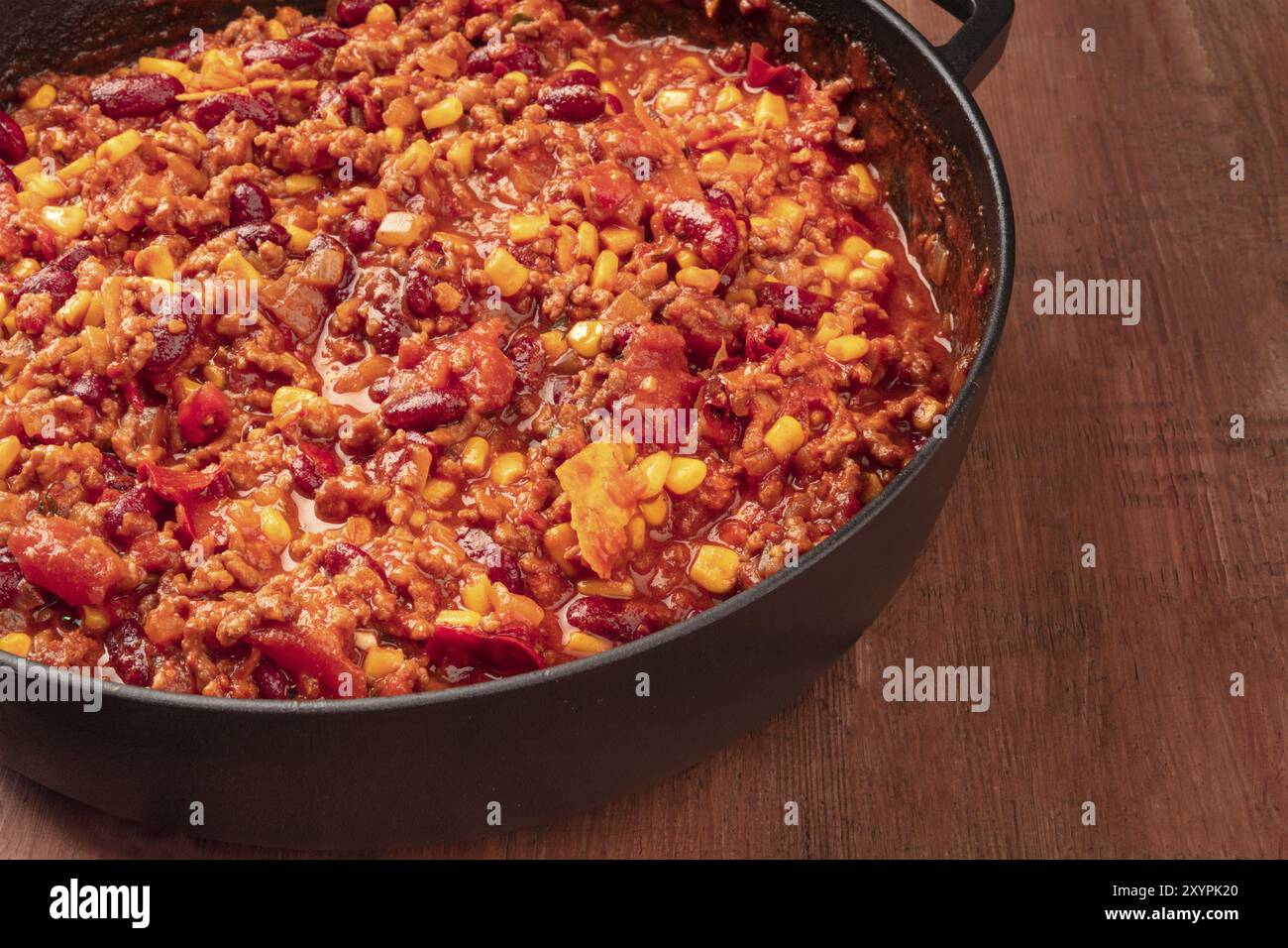 A large cast iron pan with chili con carne, traditional Mexican dish ...