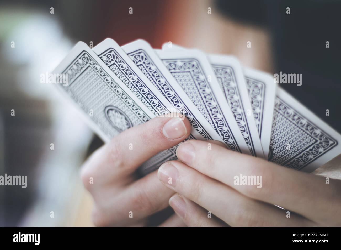 Young man is playing cards, cutout of his hands Stock Photo - Alamy