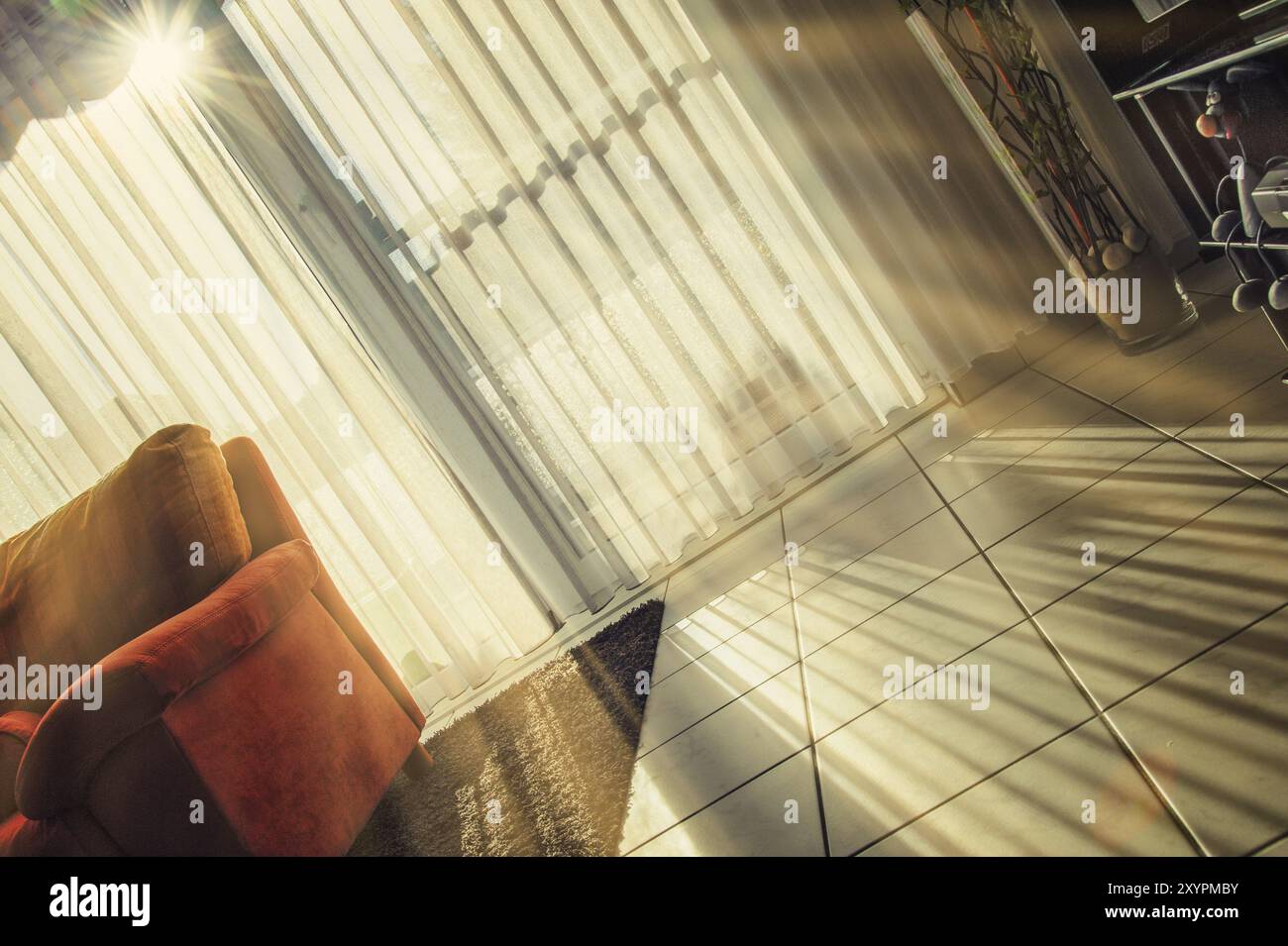 The rising sun shines through the window into a living room Stock Photo ...