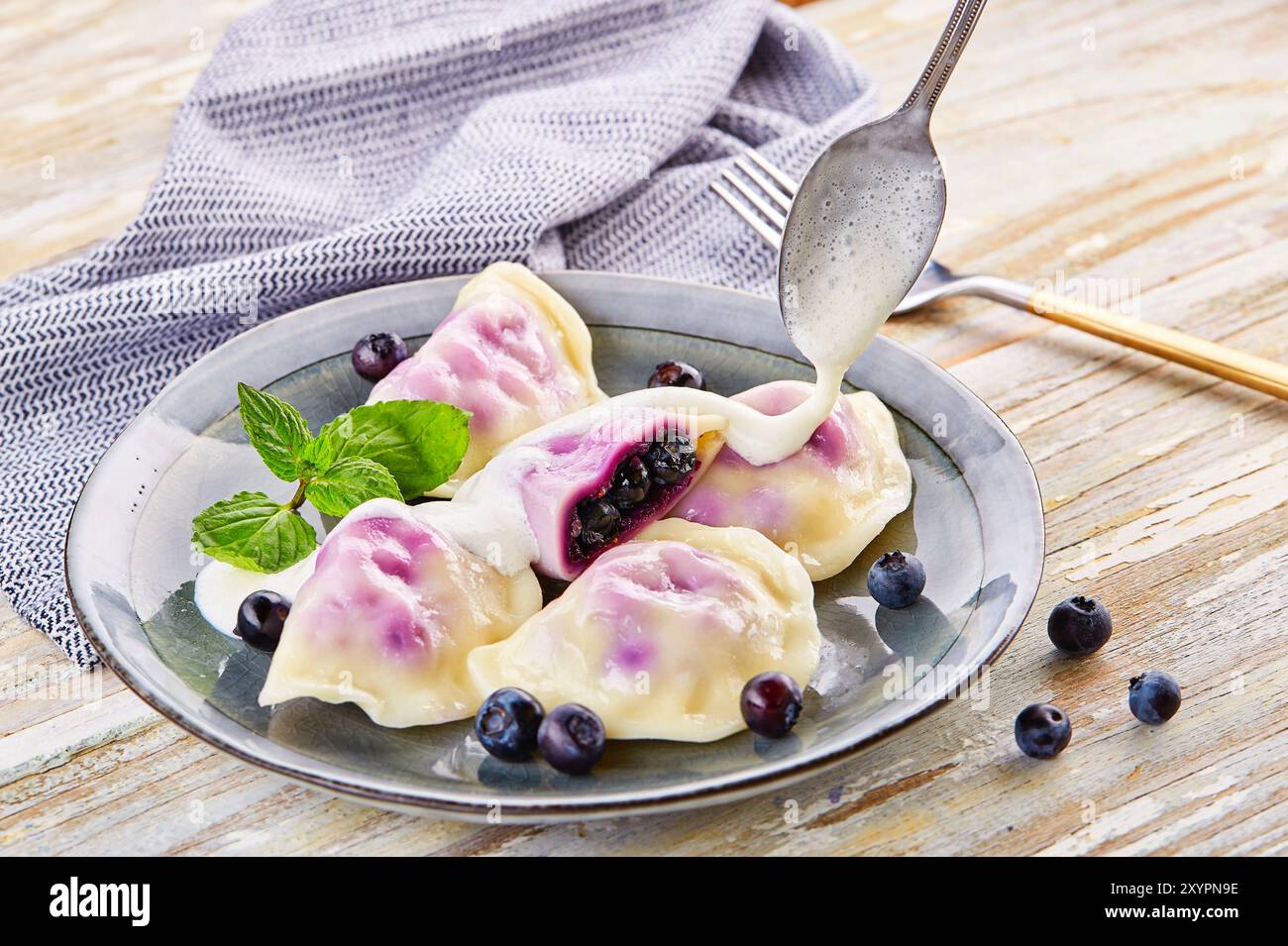 Polish tradional dish pierogi with creamy topping Stock Photo - Alamy