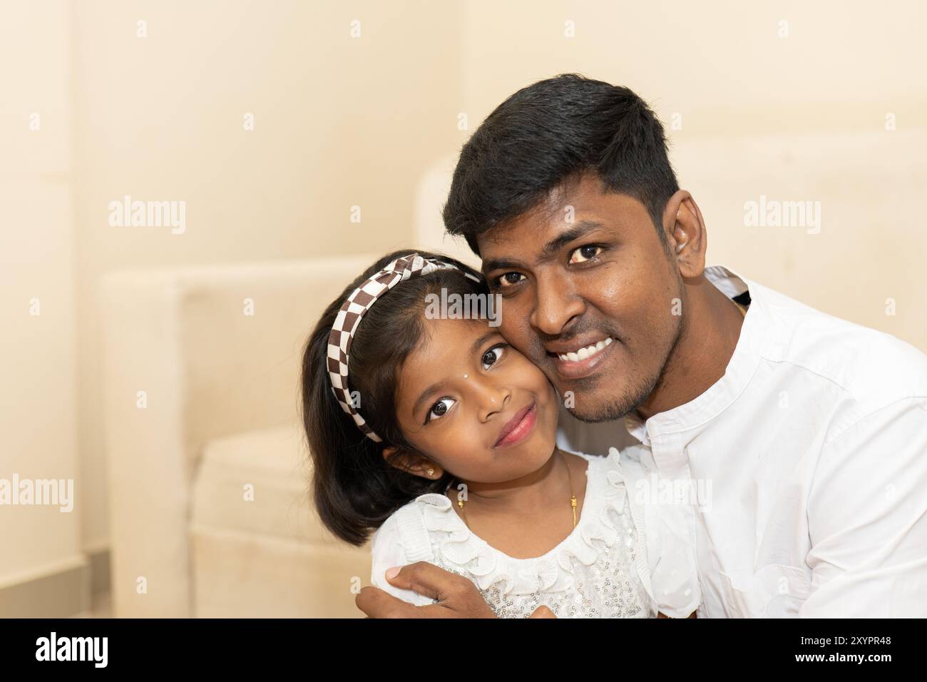 An indian Father hugs young girl affectionately Stock Photo - Alamy