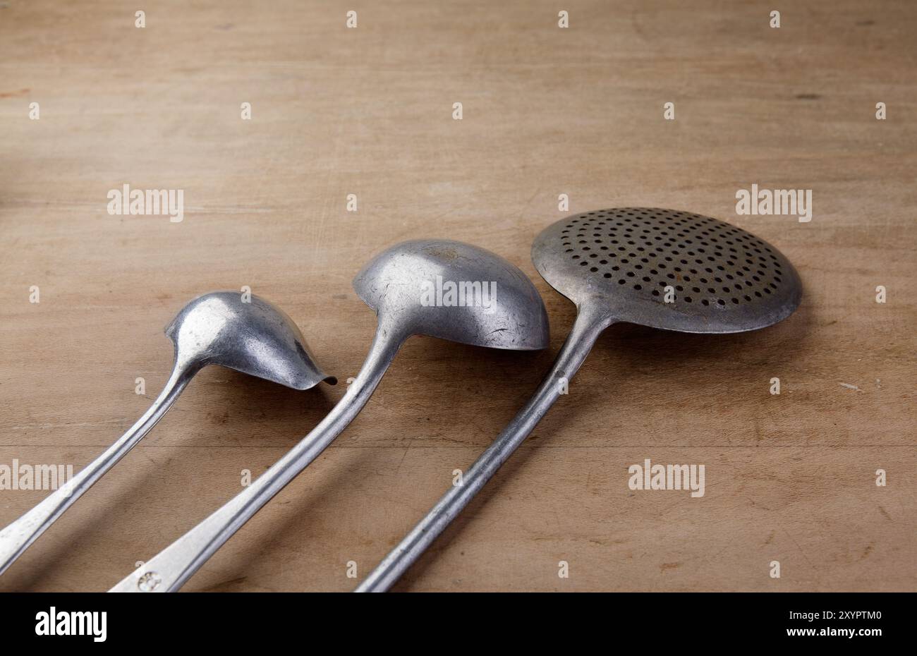 Three metal soup ladles and skimmers in different sizes Stock Photo - Alamy
