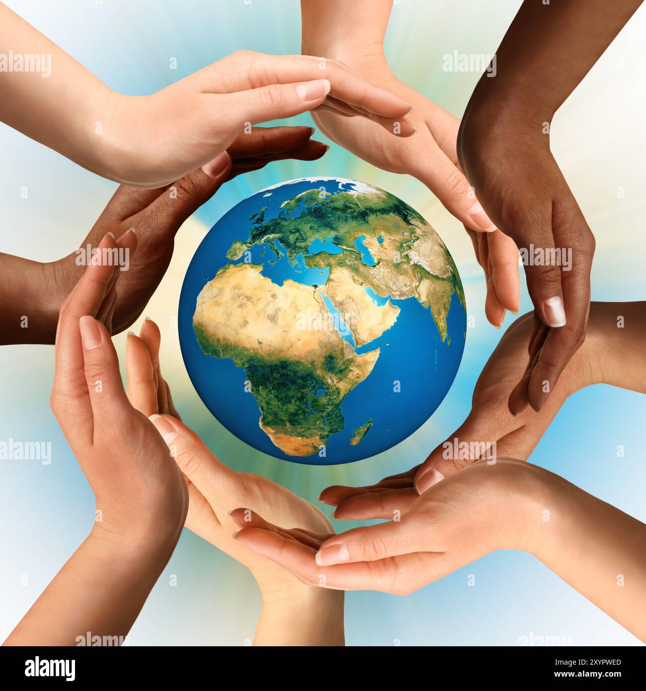 Conceptual symbol of multiracial human hands surrounding the Earth ...