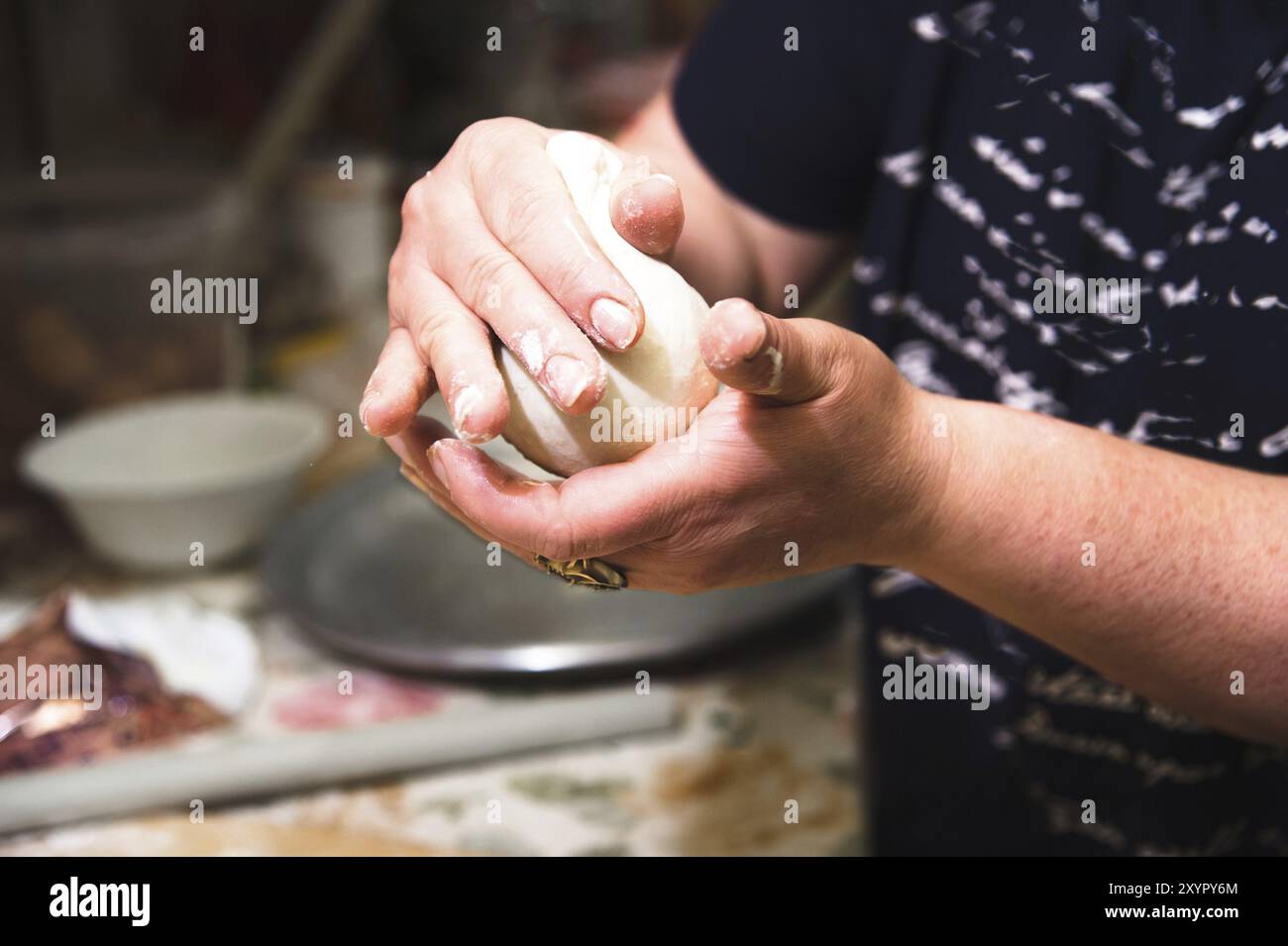 Female hands prepare a classic Caucasian khychin dish in the kitchen in ...