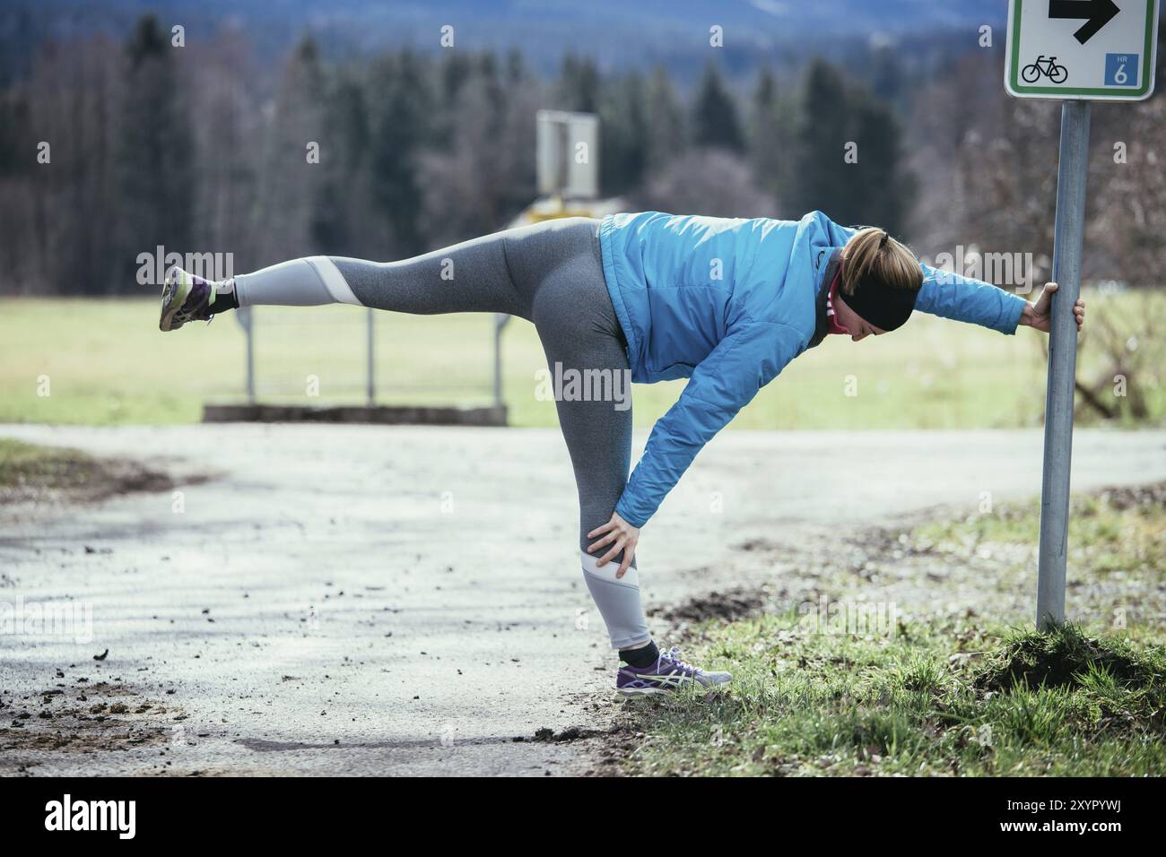 Young woman is bending and stretching before going to run Stock Photo ...