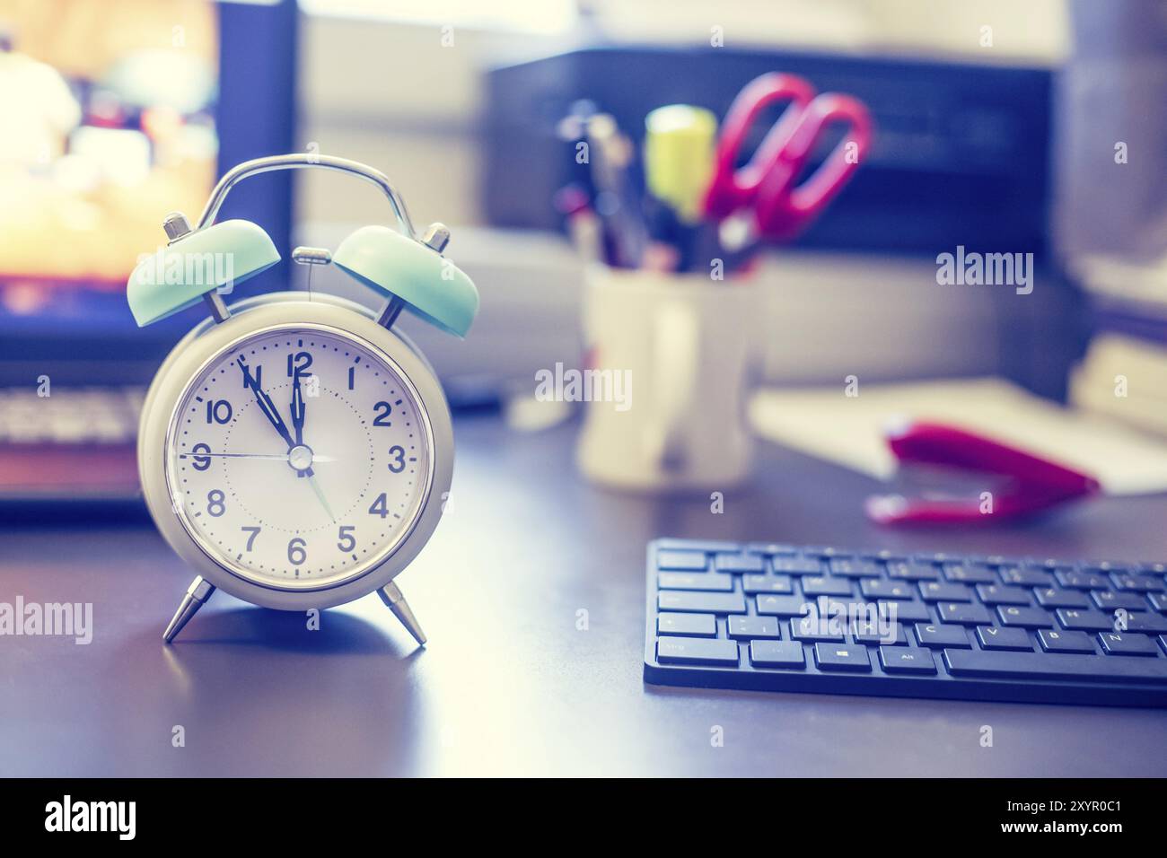 Alarm clock on the desk, office stuff in the blurry background ...