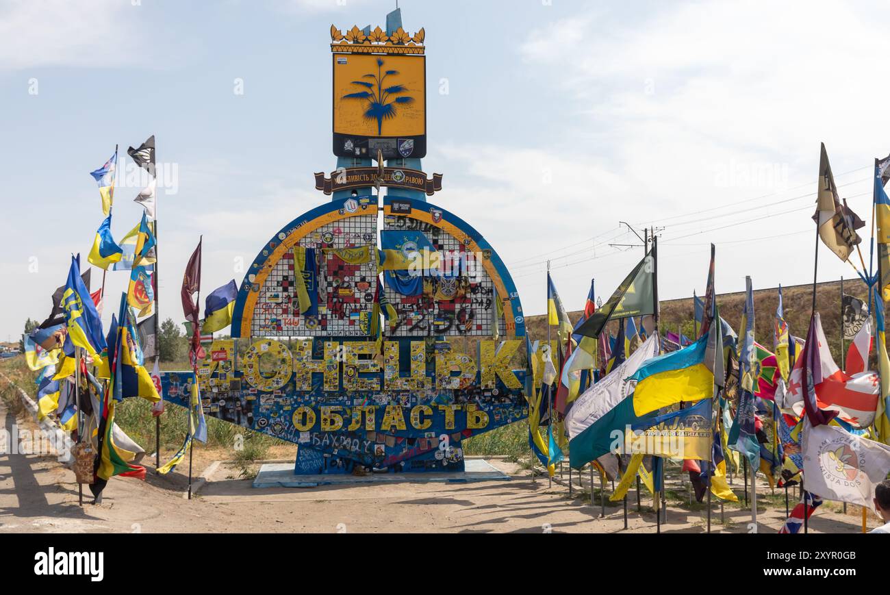 Flags of the brigades defending Donetsk region are seen near the stele ...